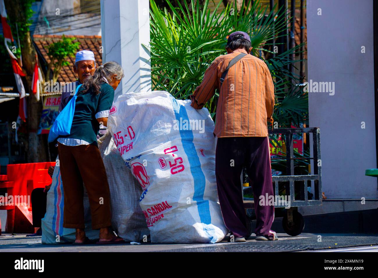Old people in shabby clothes looking for plastic bottles to sell Stock ...