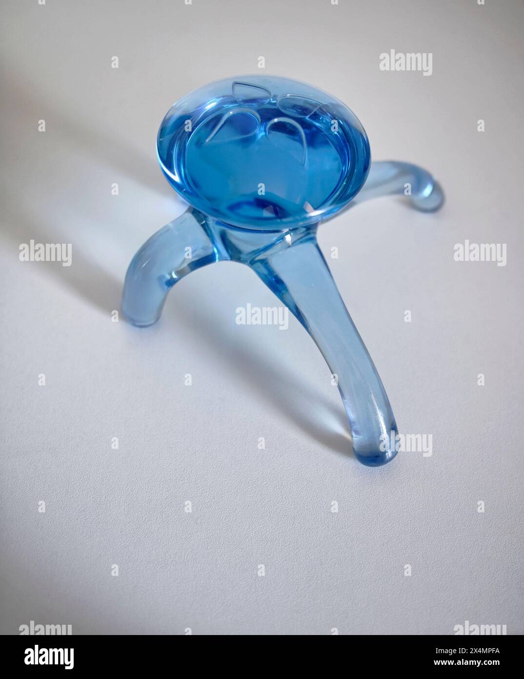 Blue plastic tool for massaging Stock Photo - Alamy