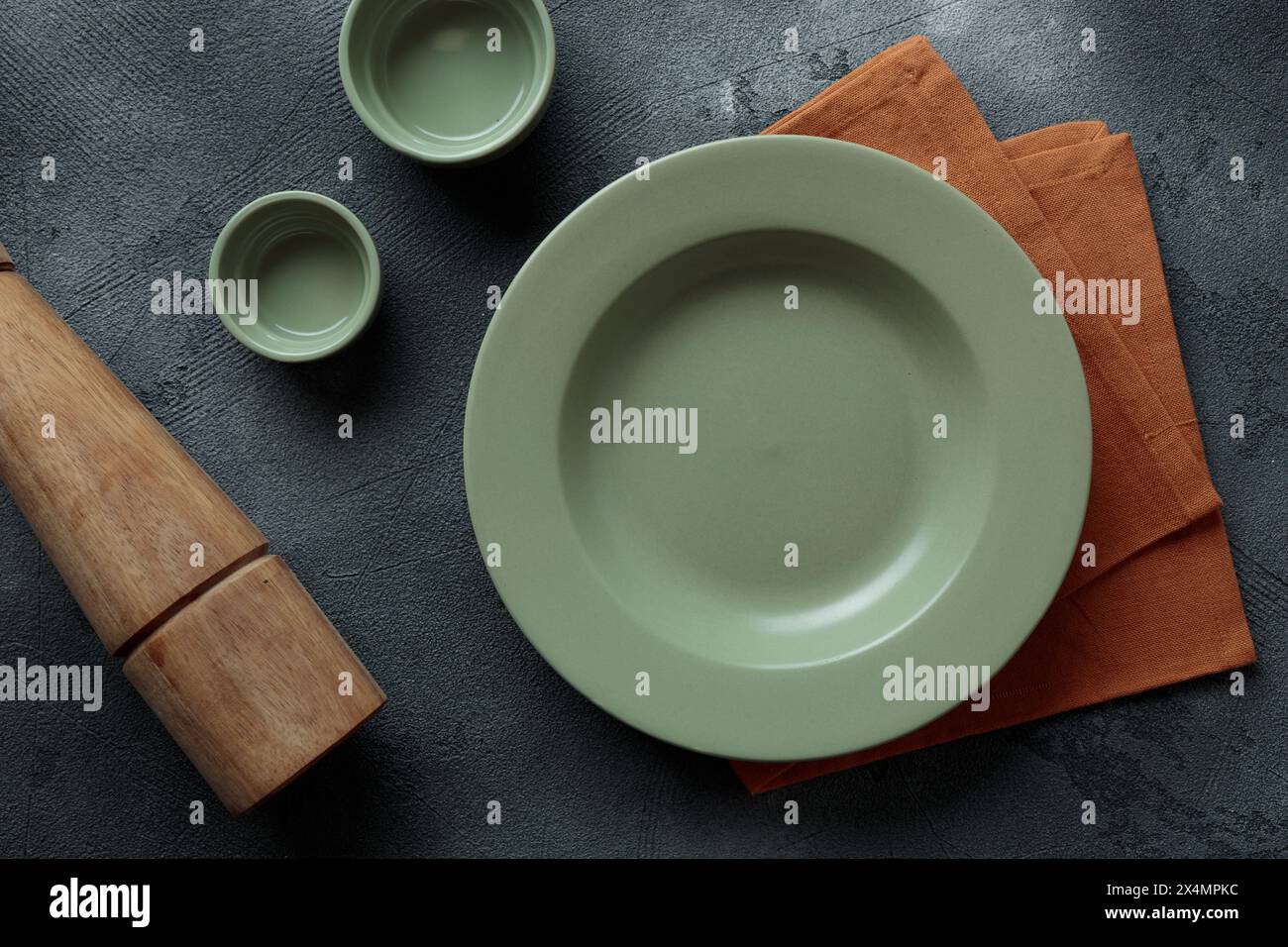 Green empty plate, cutlery and napkin on stone table top view. Table ...
