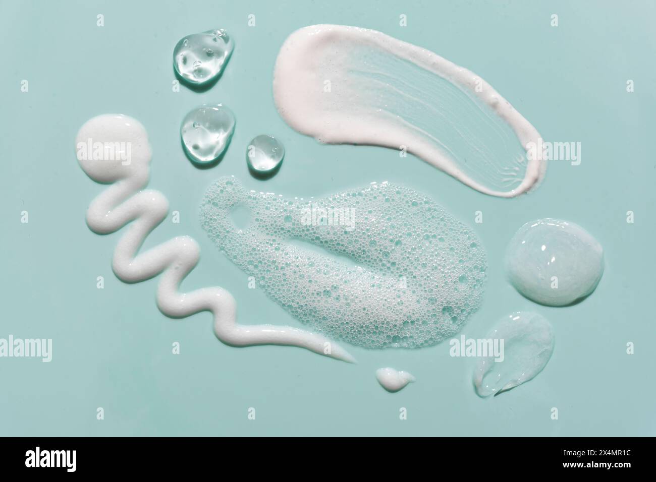 Various cosmetic skin care products smear swatches on green blue ...