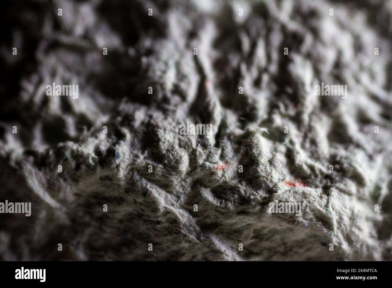 Extreme close up of old gray handmade paper mache with a structure and ...