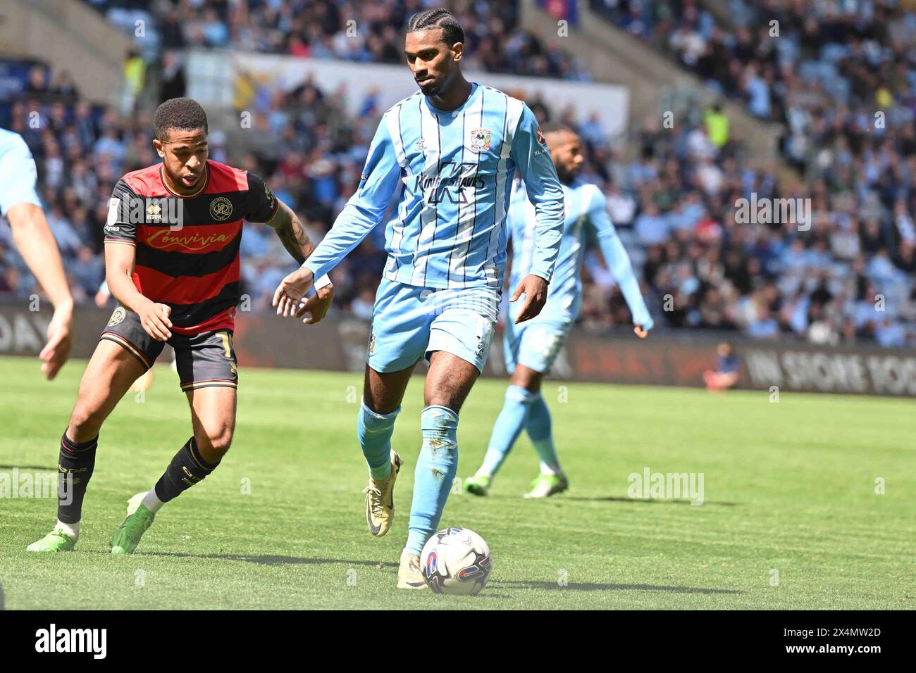 Haji Wright (11 Coventry City) challenged by Chris Willock (7 Queens ...