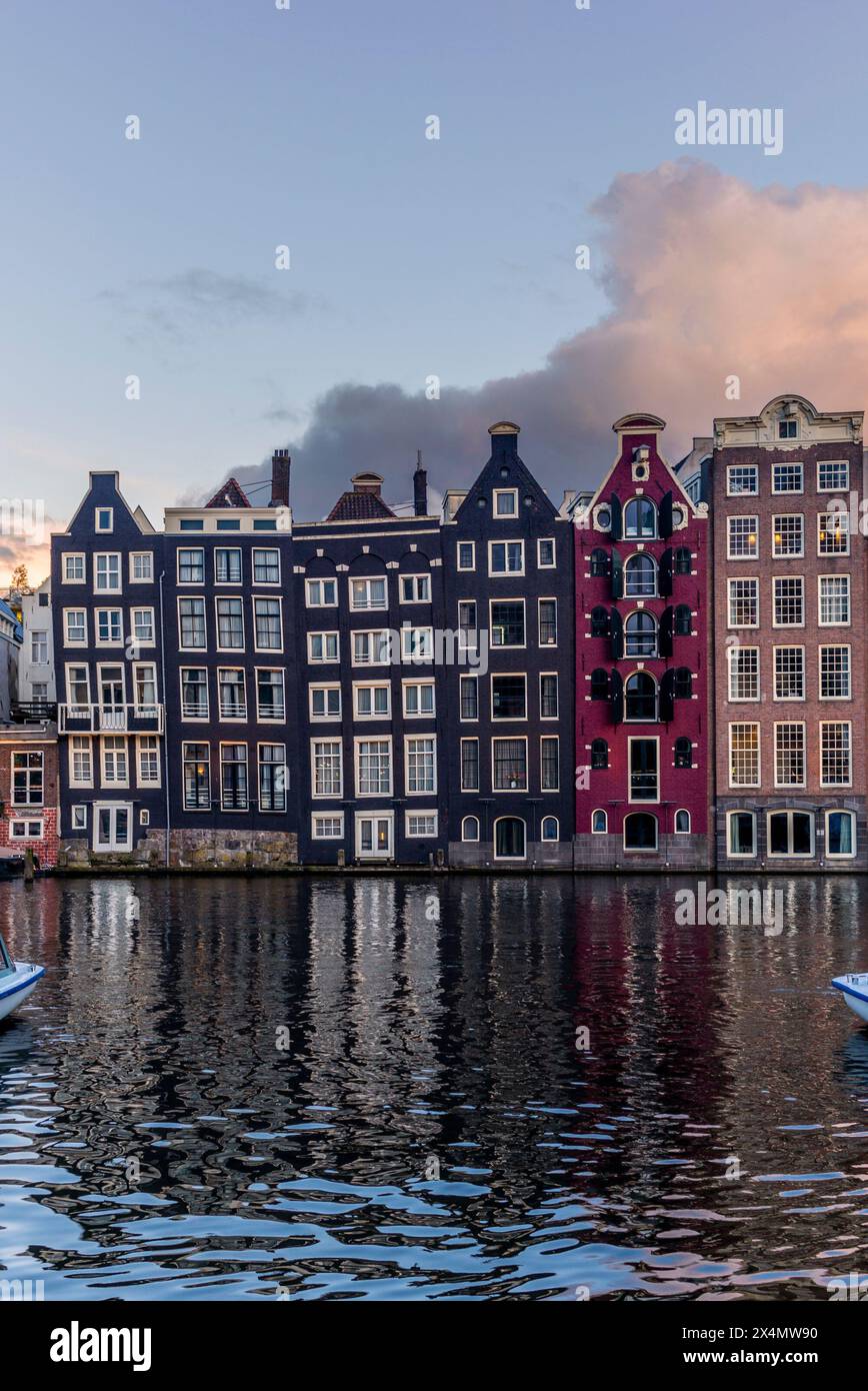 View of the Damrak canal dancing houses in Amsterdam at sunset Stock ...