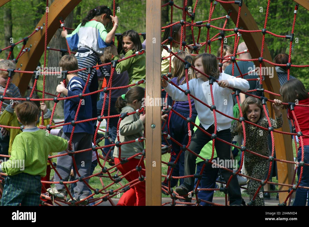 Children climb on a climbing frame and a net at the children's ...