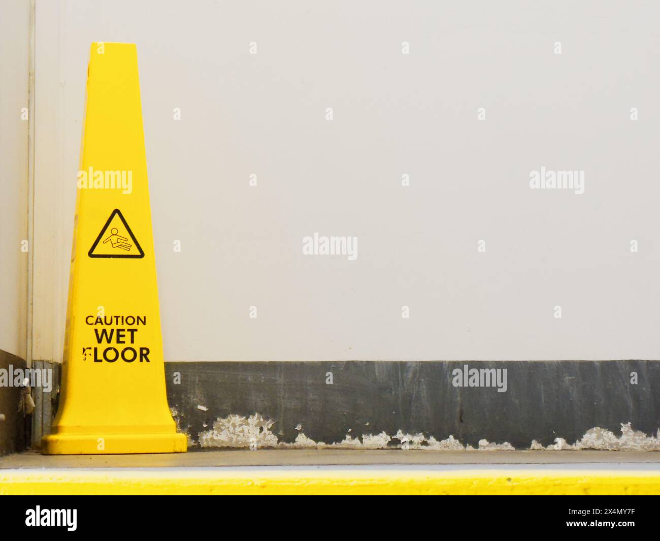 Caution wet floor cone safety notice at public stair Stock Photo - Alamy