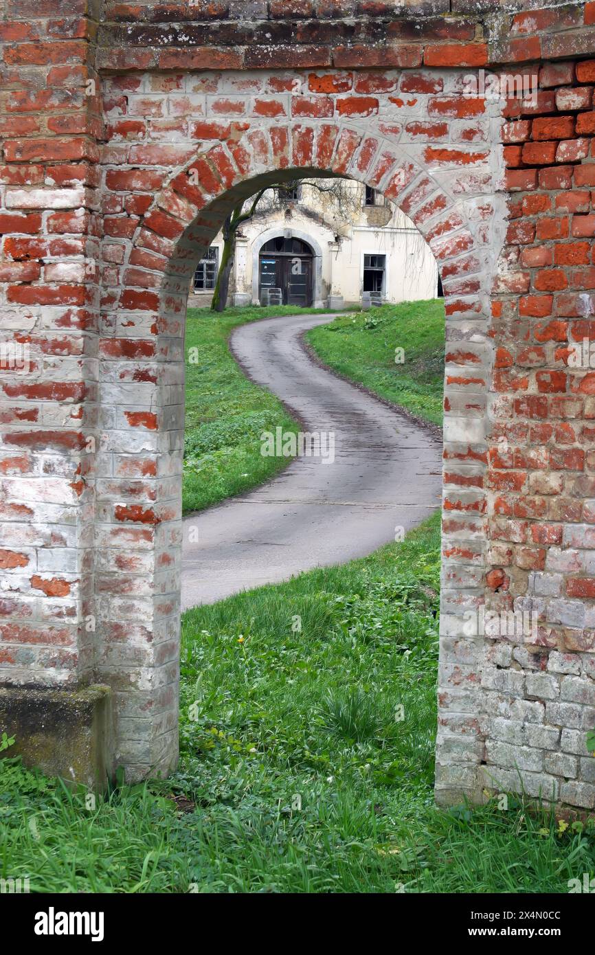 Entrance to a rustic farm with old brick walls in the Pokupje region ...