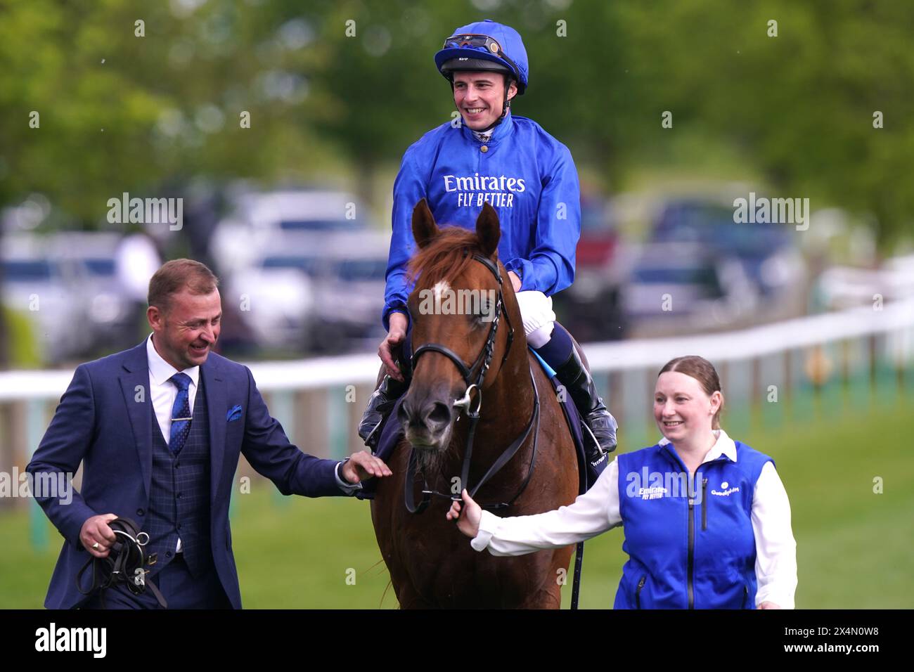Jockey William Buick (centre) celebrates after winning the QIPCO 2000 ...