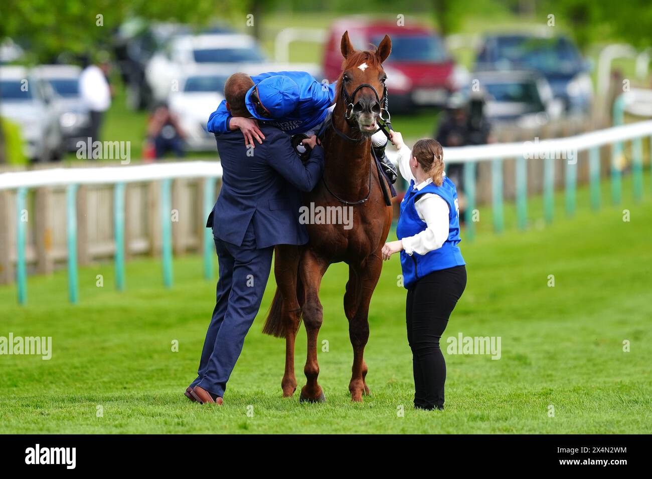Jockey William Buick (centre) celebrates after winning the QIPCO 2000 ...