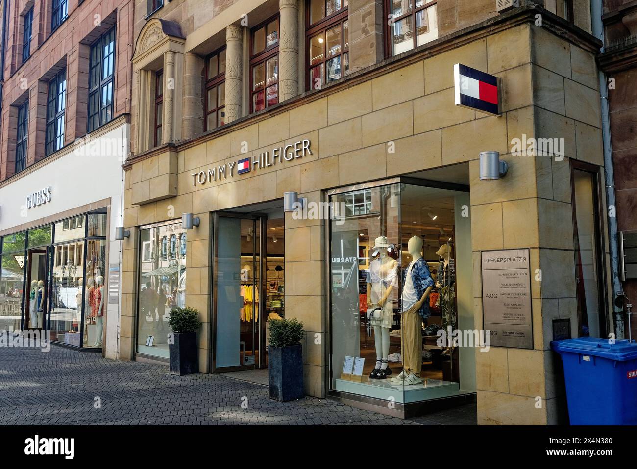 Lettering of the fashion retailers Hilfiger and Guess on the facade of ...