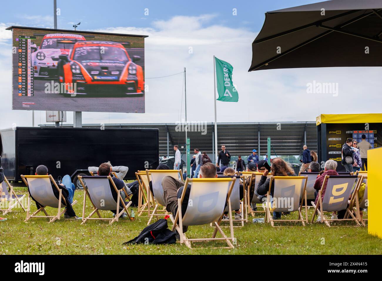 Oschersleben, Germany. 29th April, 2024. Fans enjoy sit lounge chair ...
