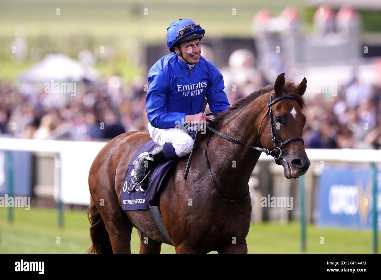 Jockey William Buick (centre) celebrates after winning the QIPCO 2000 ...