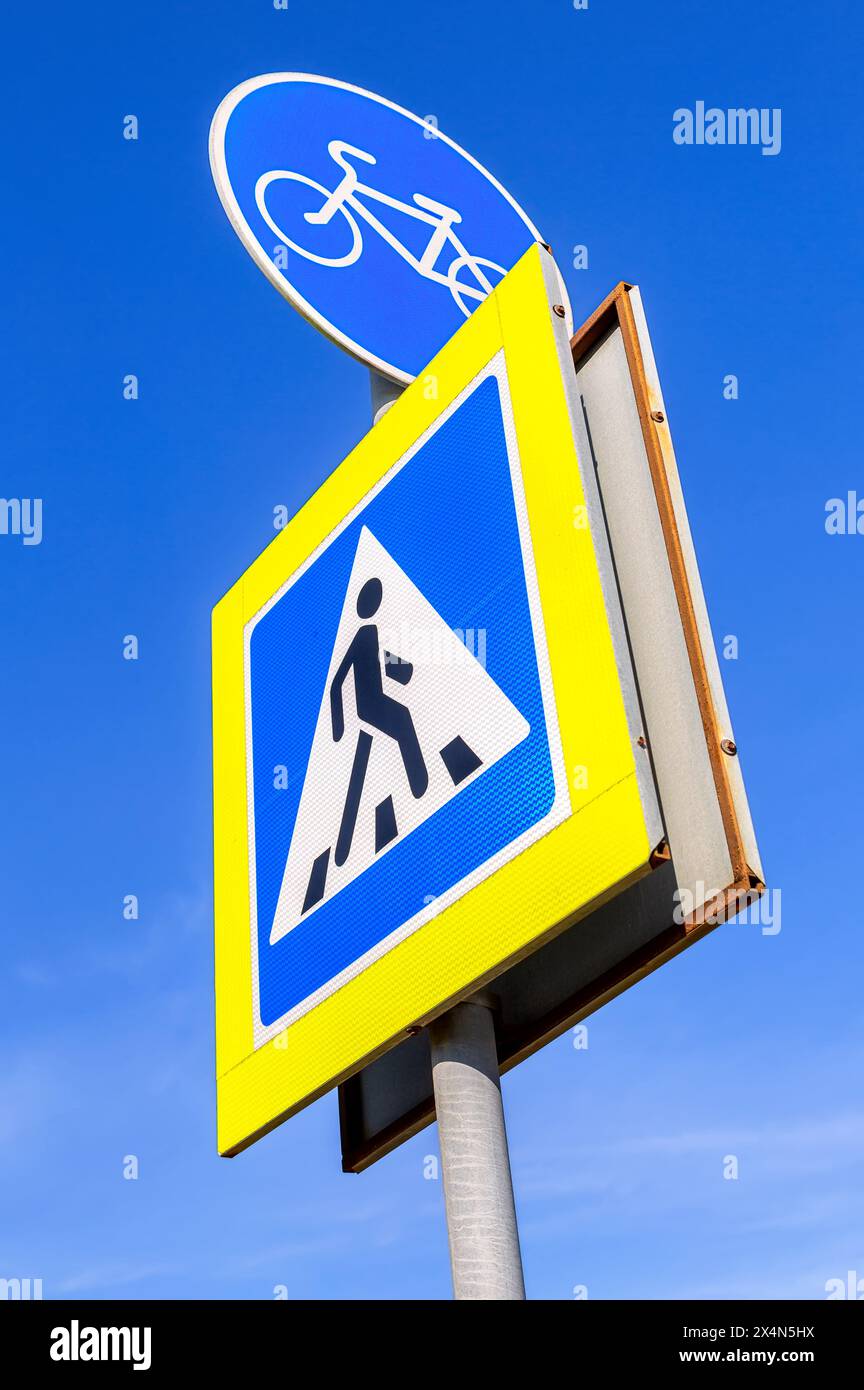 Bicycle road sign for bikes lane and pedestrian crossing sign against ...