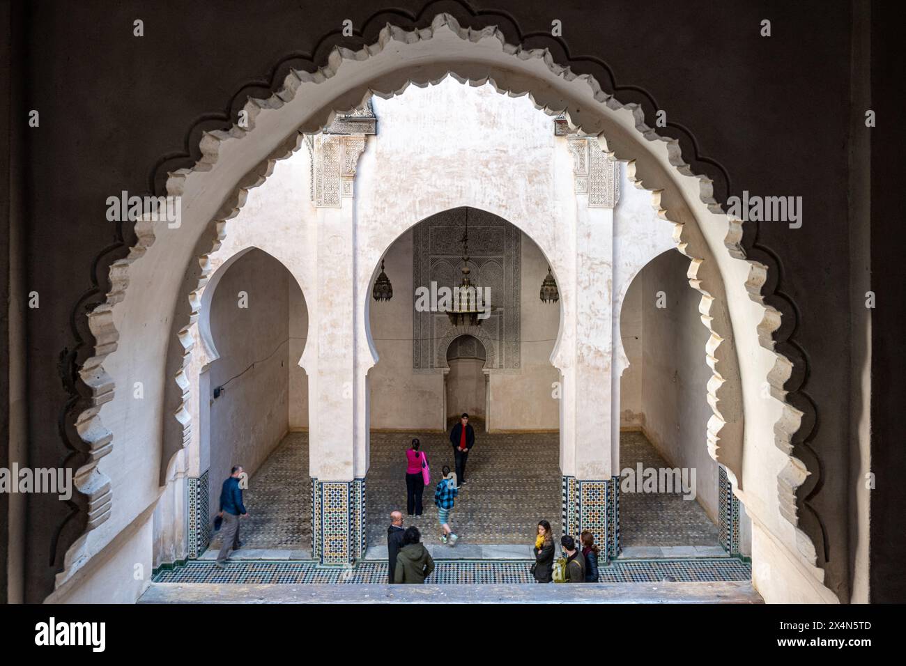 A tranquil view captures the essence of Fez through the ornate window ...