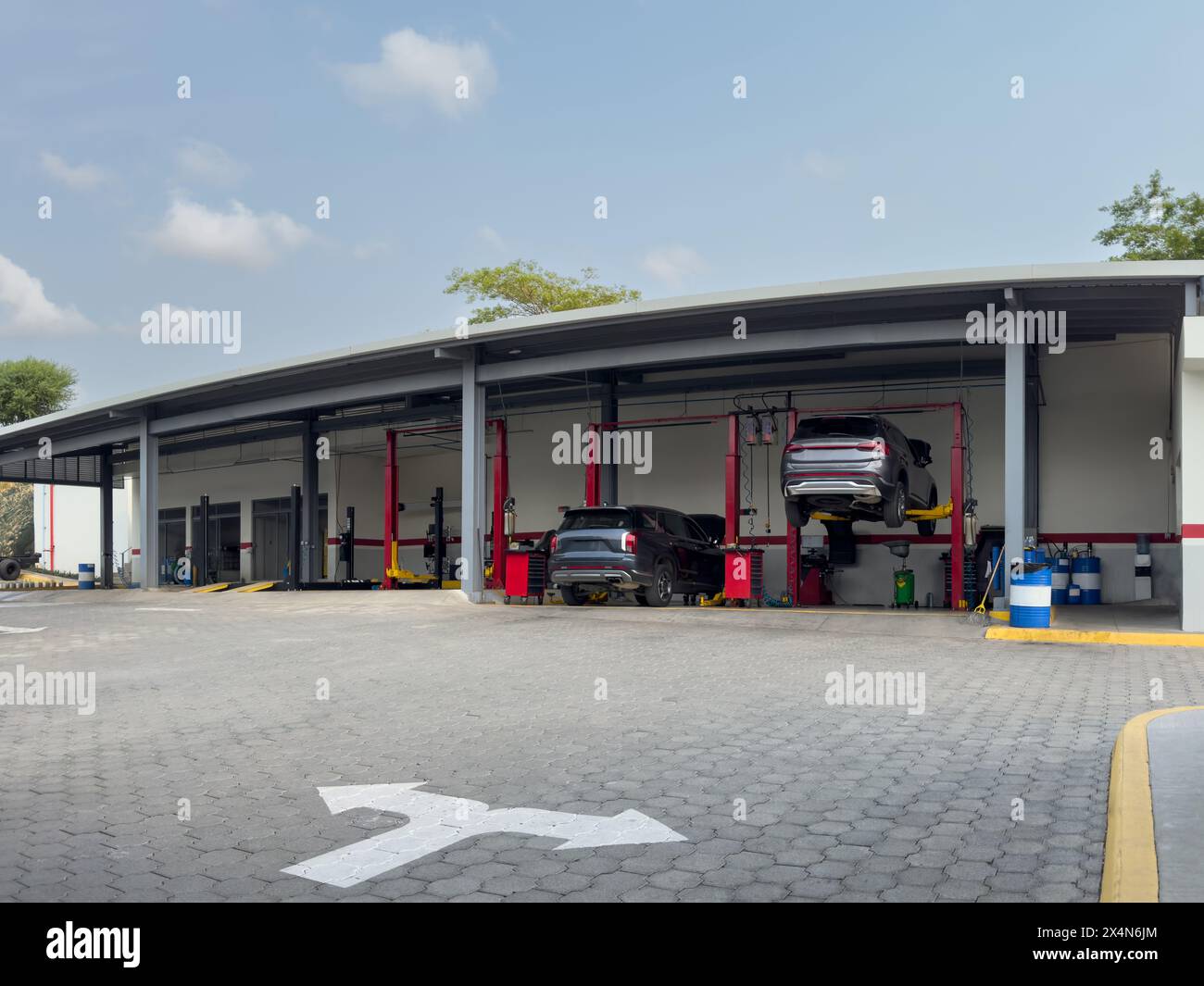 Car maintenance station with lift on blue sky background Stock Photo ...