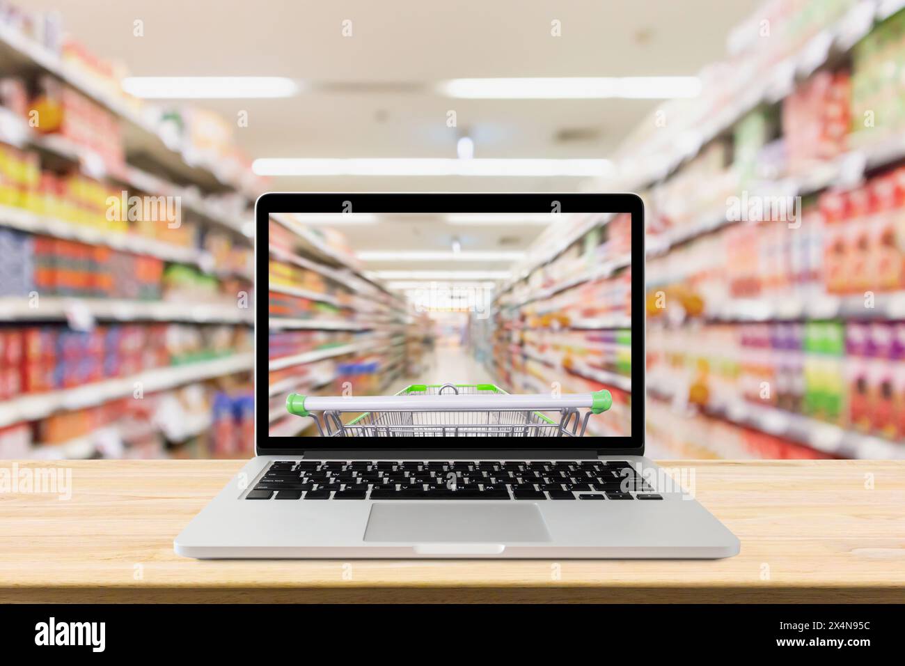 laptop computer on wood table with supermarket aisle blurred background ...