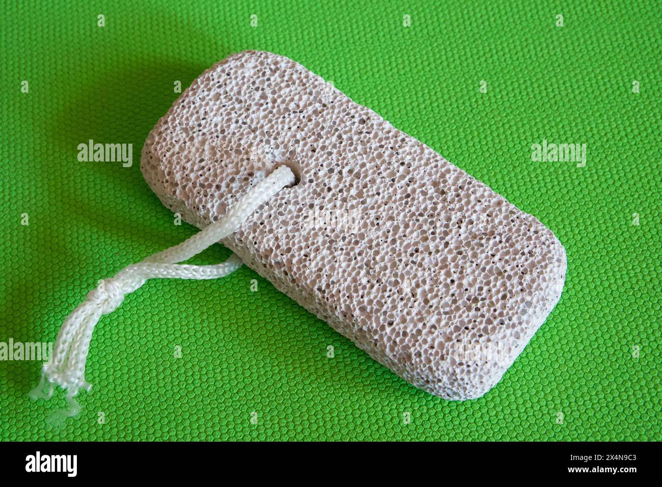 Skincare Tool Display. Pumice stone with string, presented on vibrant ...