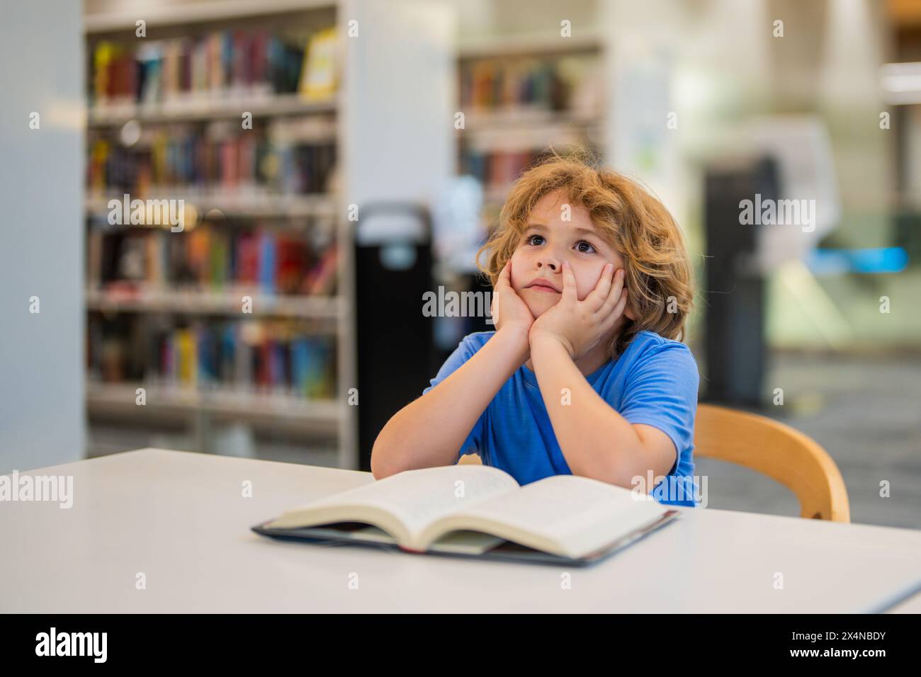 Kid reading book. Child reading book in a public library. School kid ...