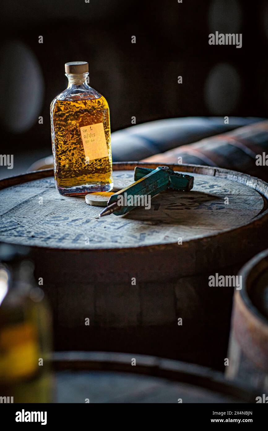 Whisky bottle with bung puller and barrel at Raasay distillery on the ...