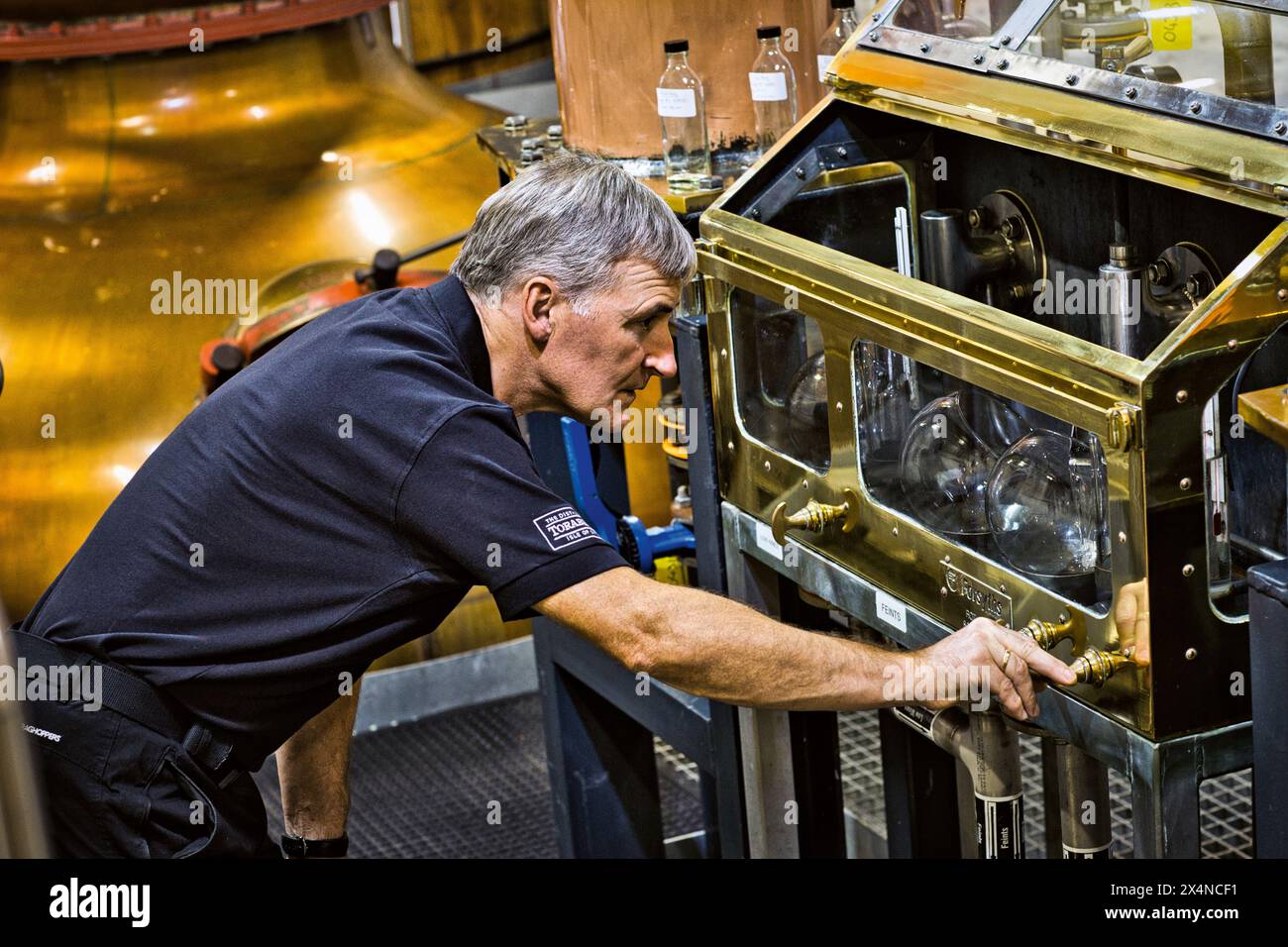 Still man checks alcohol levels in the Spirit Safe at Torabhaig ...