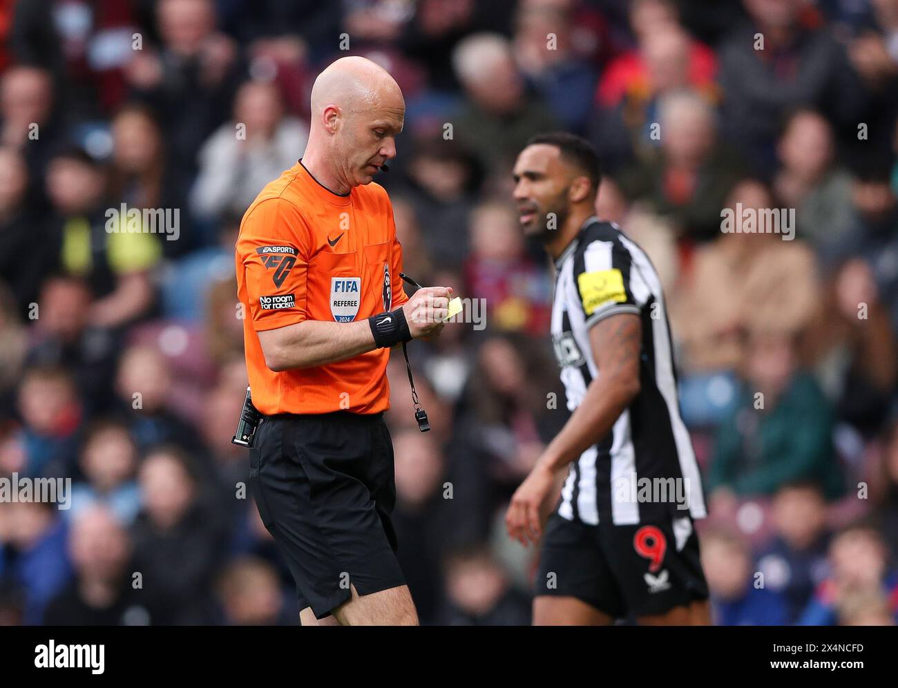 Newcastle United's Callum Wilson (right) is shown a yellow card by ...