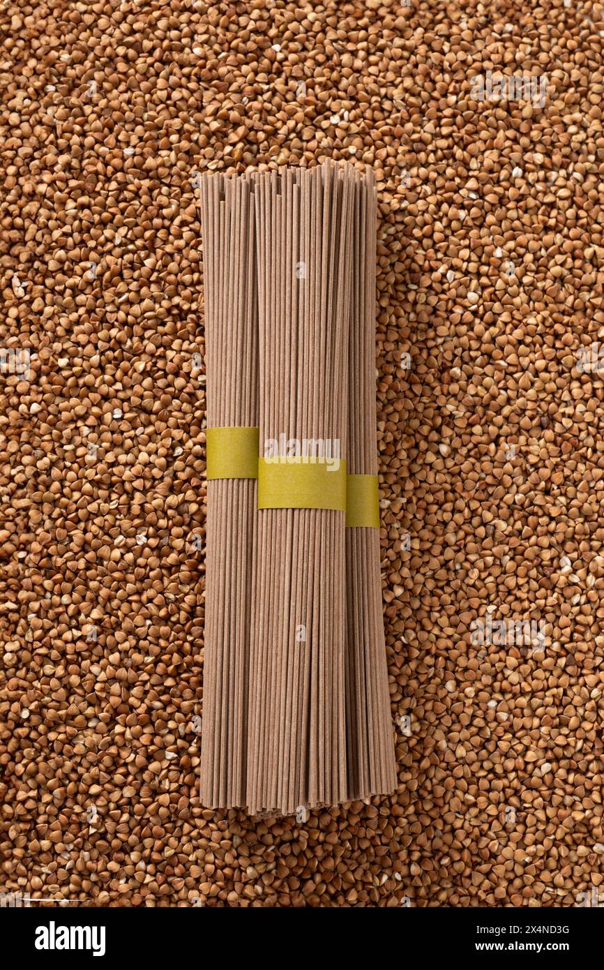 Raw buckwheat noodles soba in bundle on grain. Healthy vegan diet ...