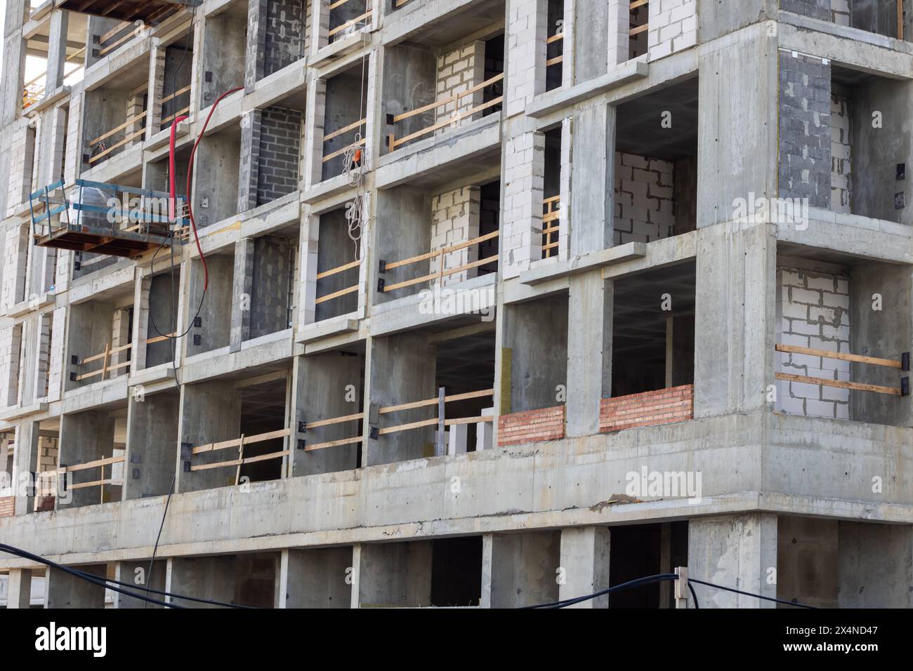 A tower block under construction, featuring a facade with numerous ...