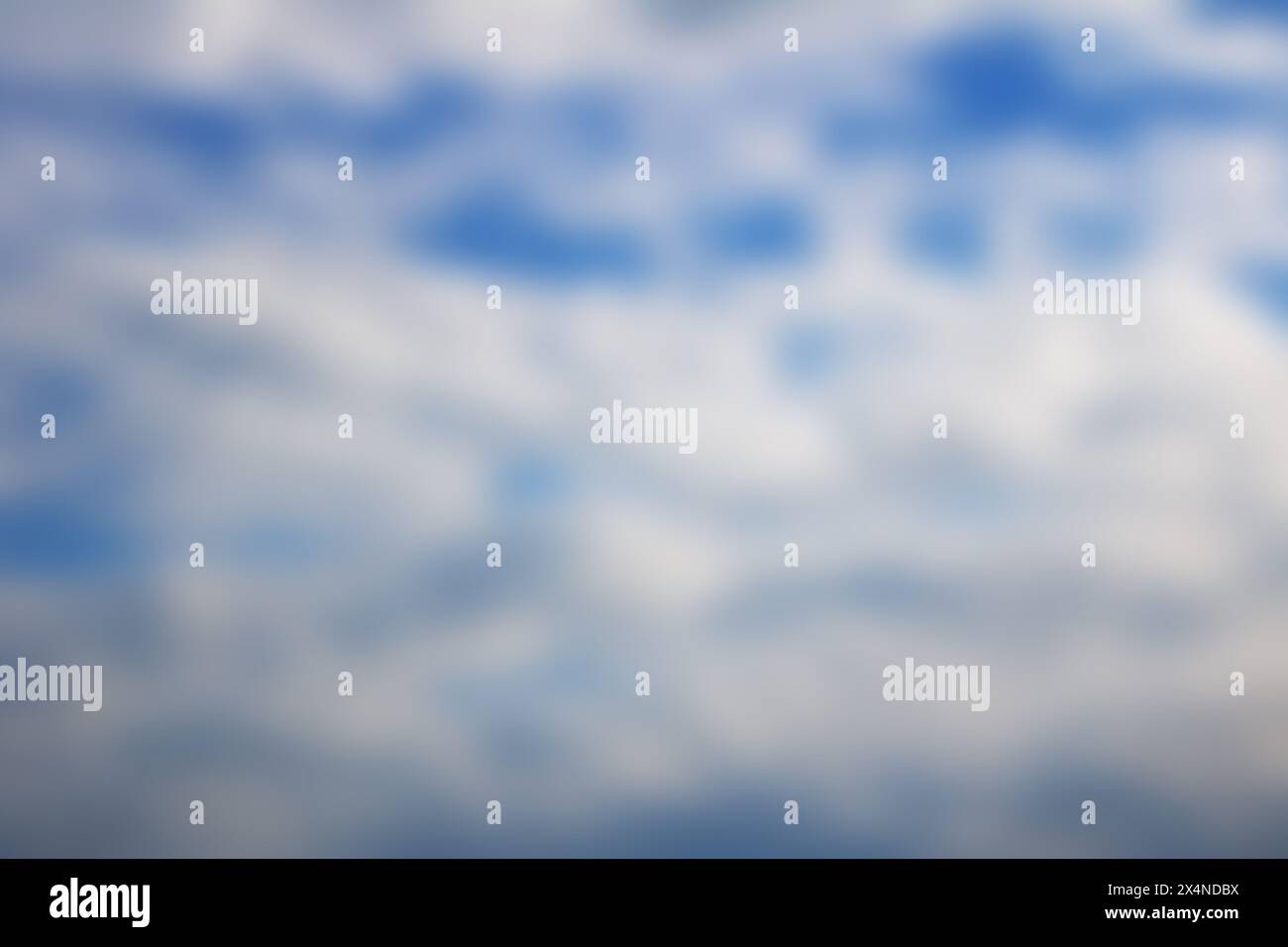 An electric blue sky filled with fluffy white cumulus clouds, creating ...