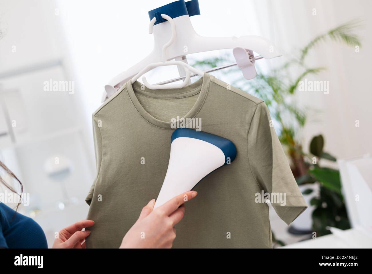Using steaming iron to ironing t-shirt in home. Doing stream vapor iron ...
