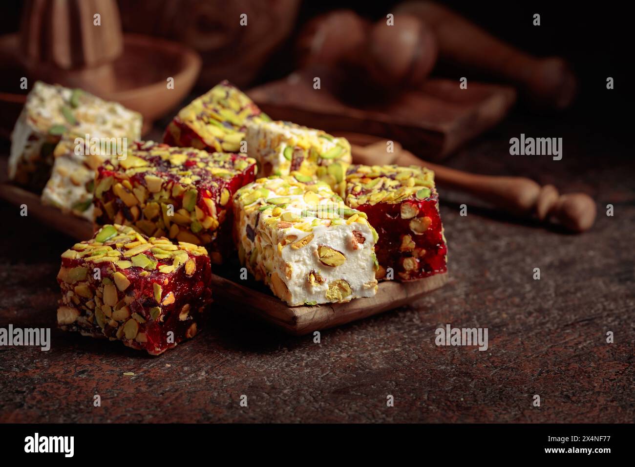 Traditional Turkish delight on an old brown table with wooden kitchen ...