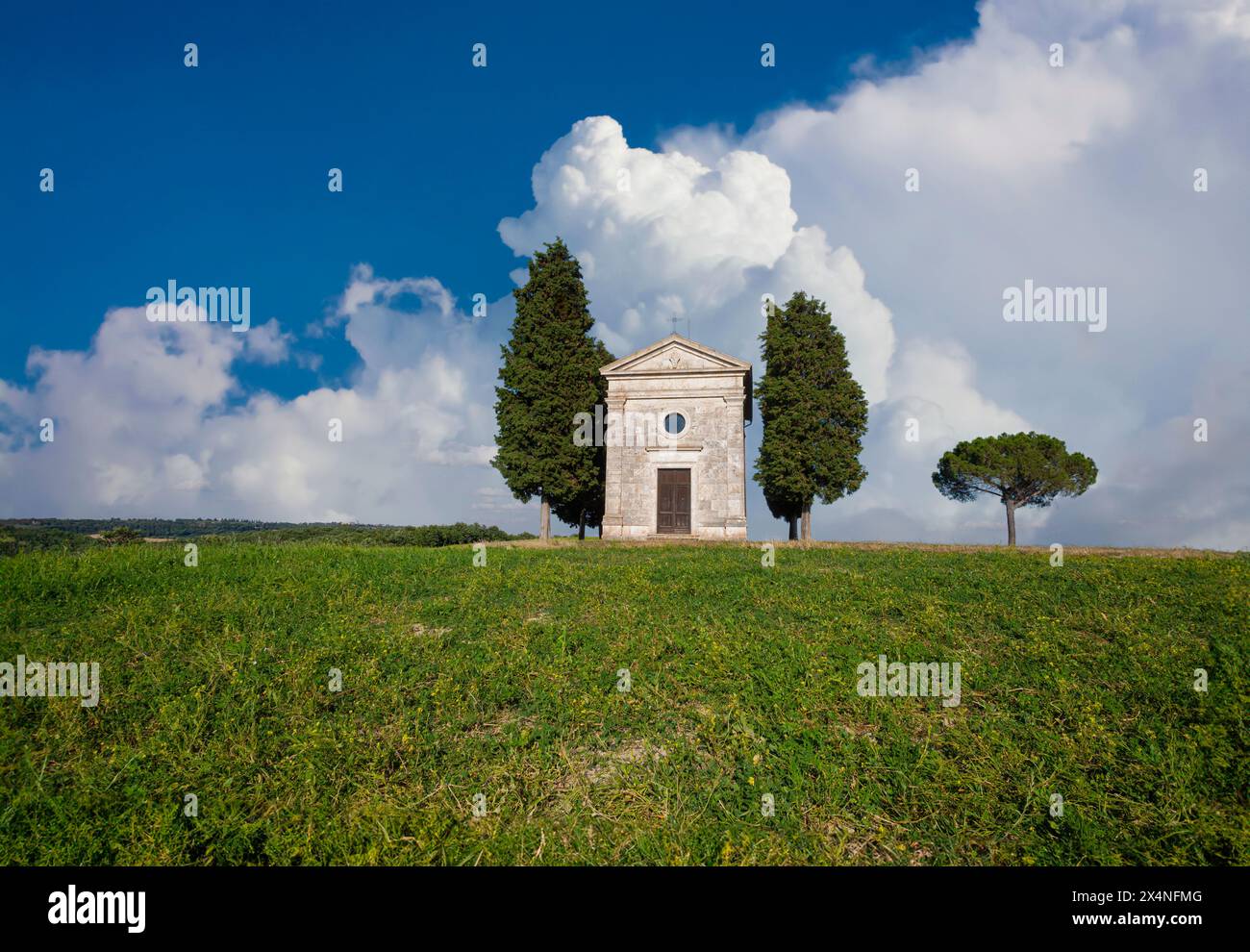 Bright blue sky over the peaceful Madonna di Vitaleta Chapel in Siena ...