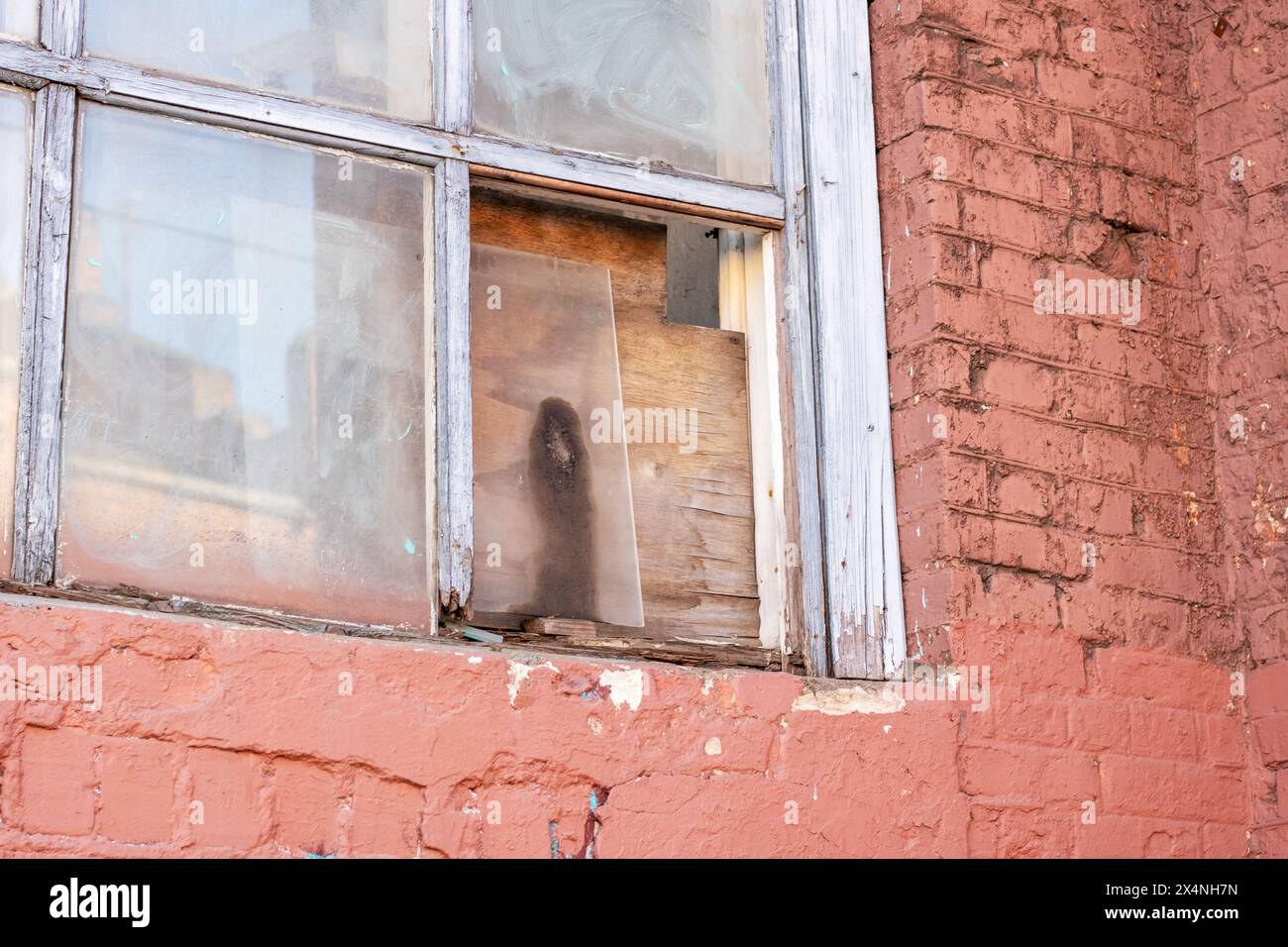 Brown wood fixture with broken window in brick wall facade Stock Photo ...