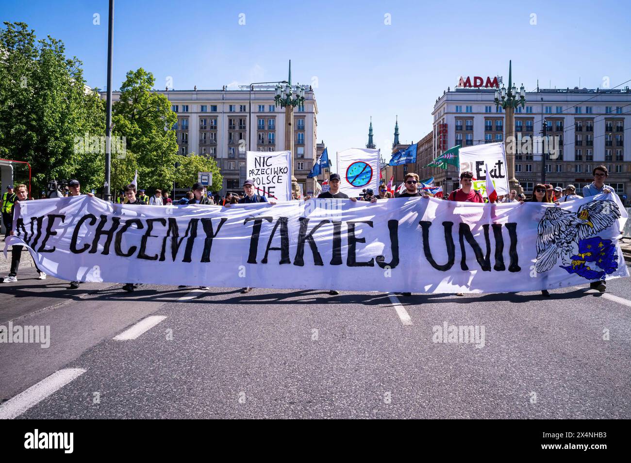 Anti-EU demonstrators march behind a Polish eagle and in front of ...