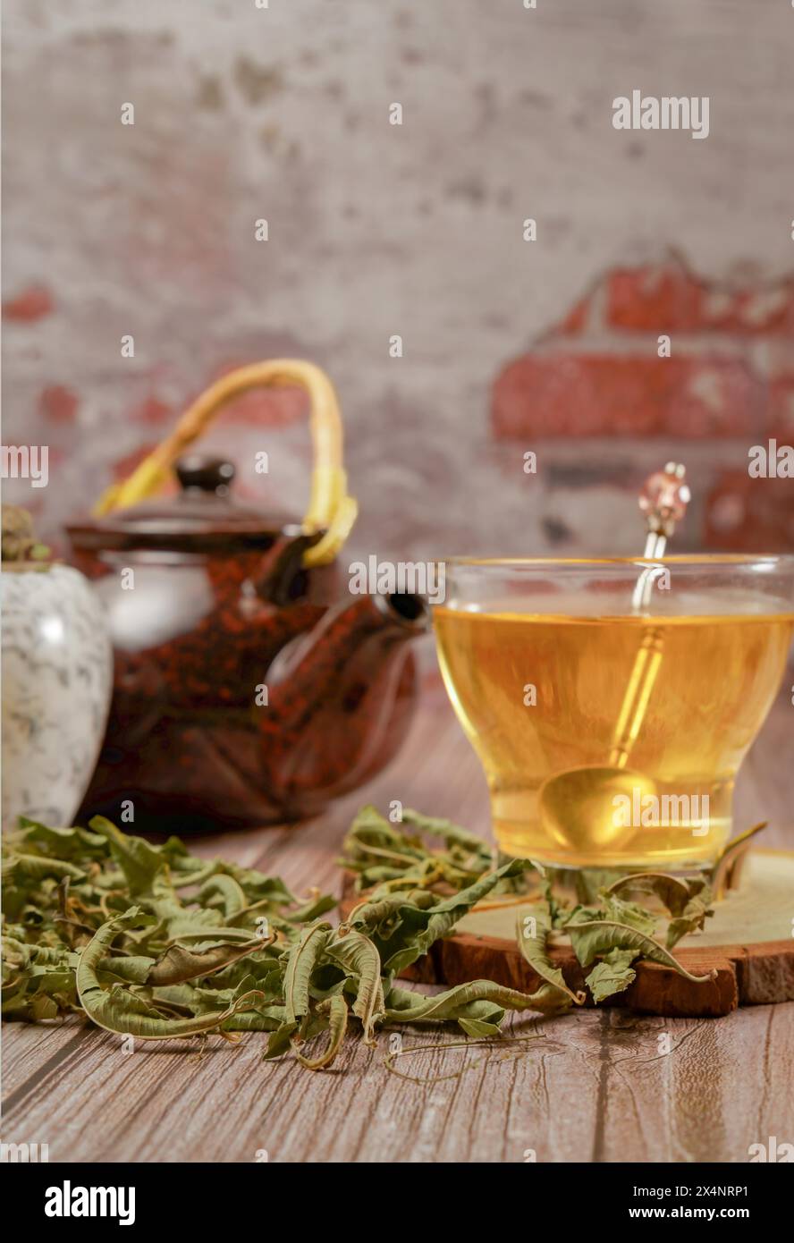 Lemon verbena infusion in a glass cup with a marble mortar and pestle ...