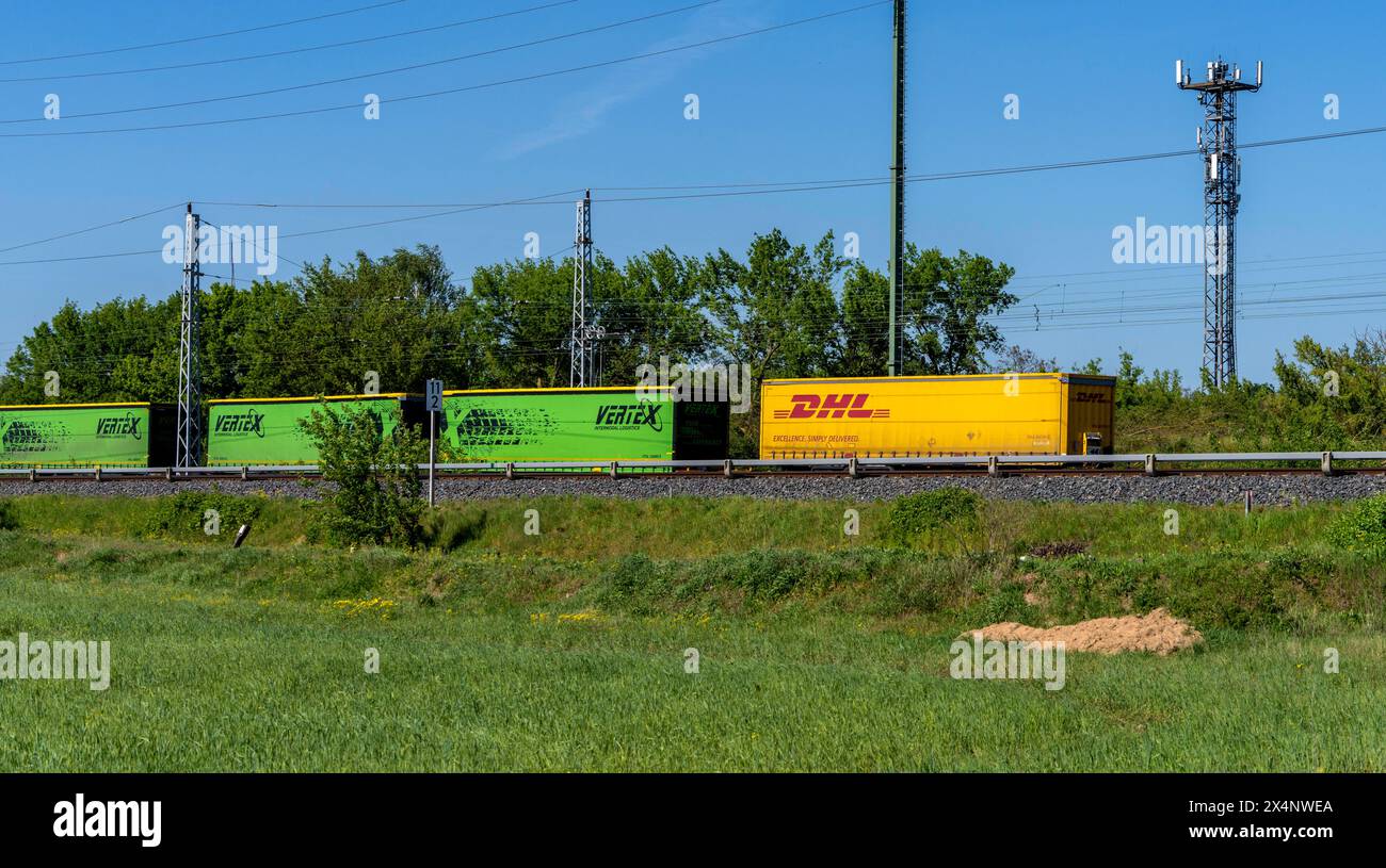 Goods train on a railway line in the landscape of Berlin-Beech, Germany ...