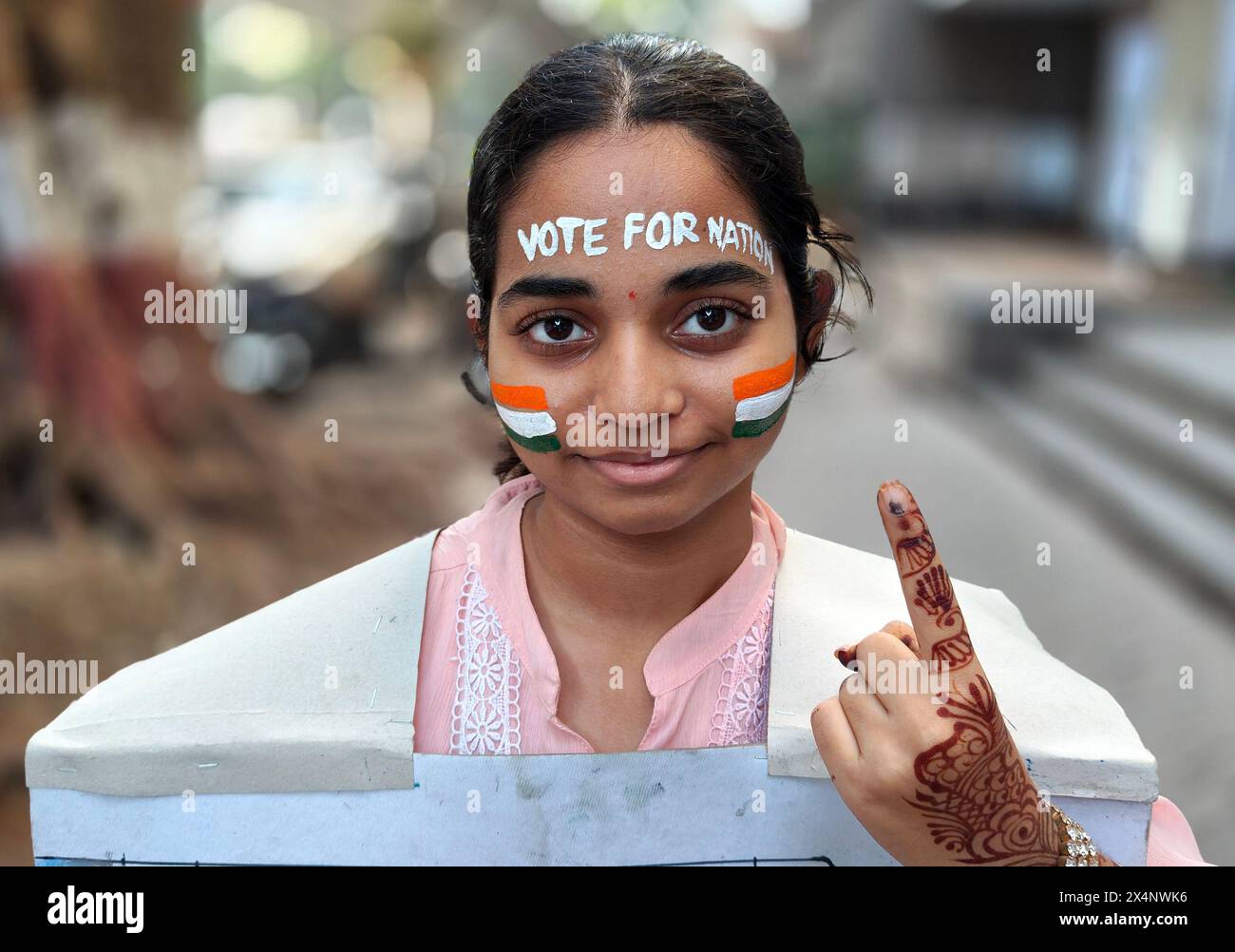 A student from Gurukul school of art with her face painted to create ...