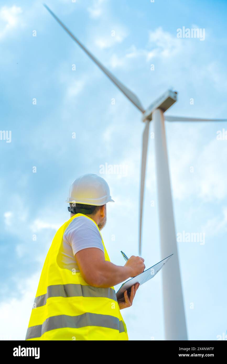 Vertical photo with low angle view of an engineer writing notes ...