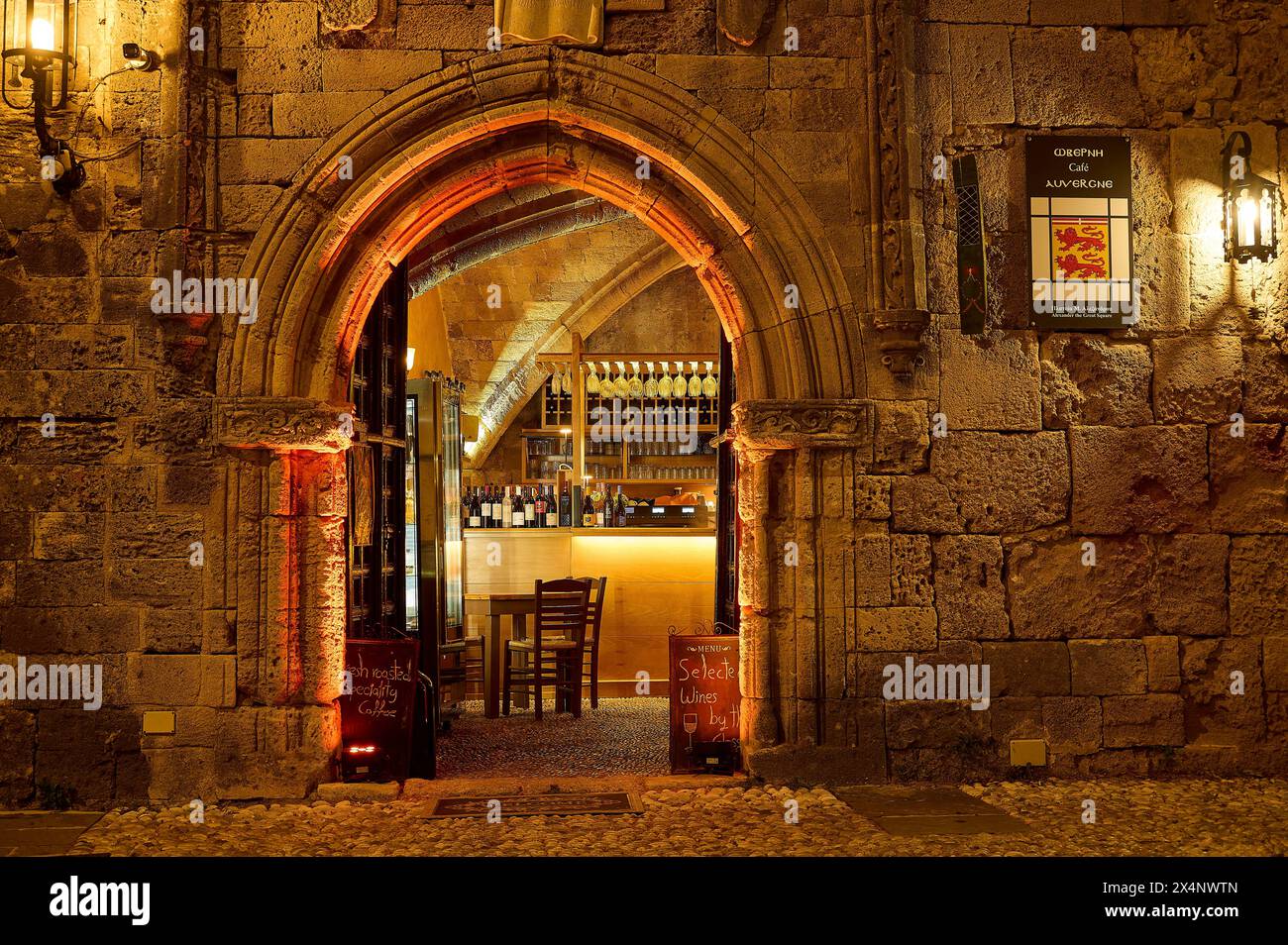 Illuminated entrance of a restaurant with warm light and vaulted ...