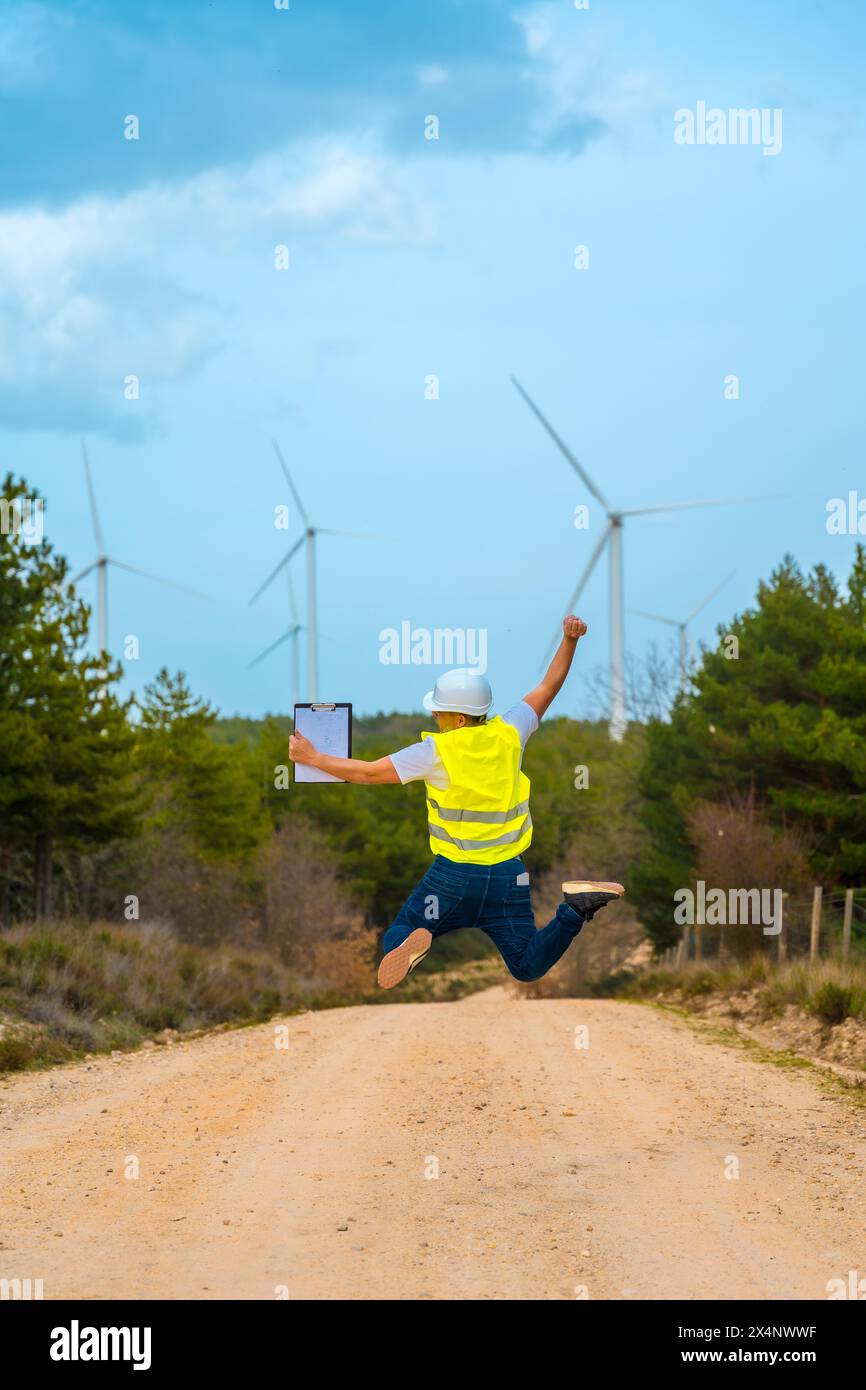 Vertical rear view of a male caucasian adult engineer celebrating ...