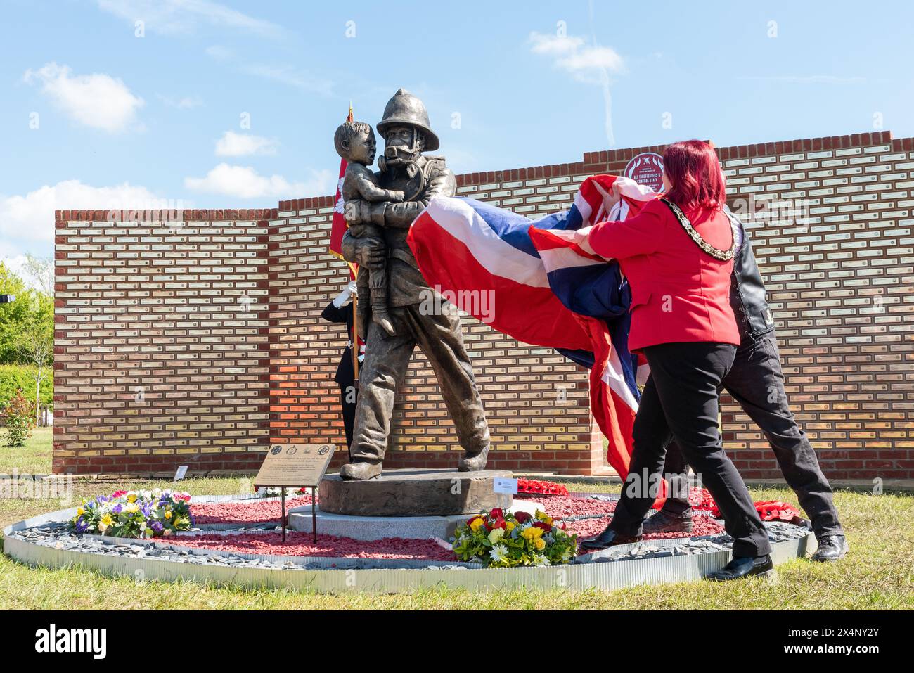 Firefighter statue, rescuing a child, at the unveiling and opening of ...