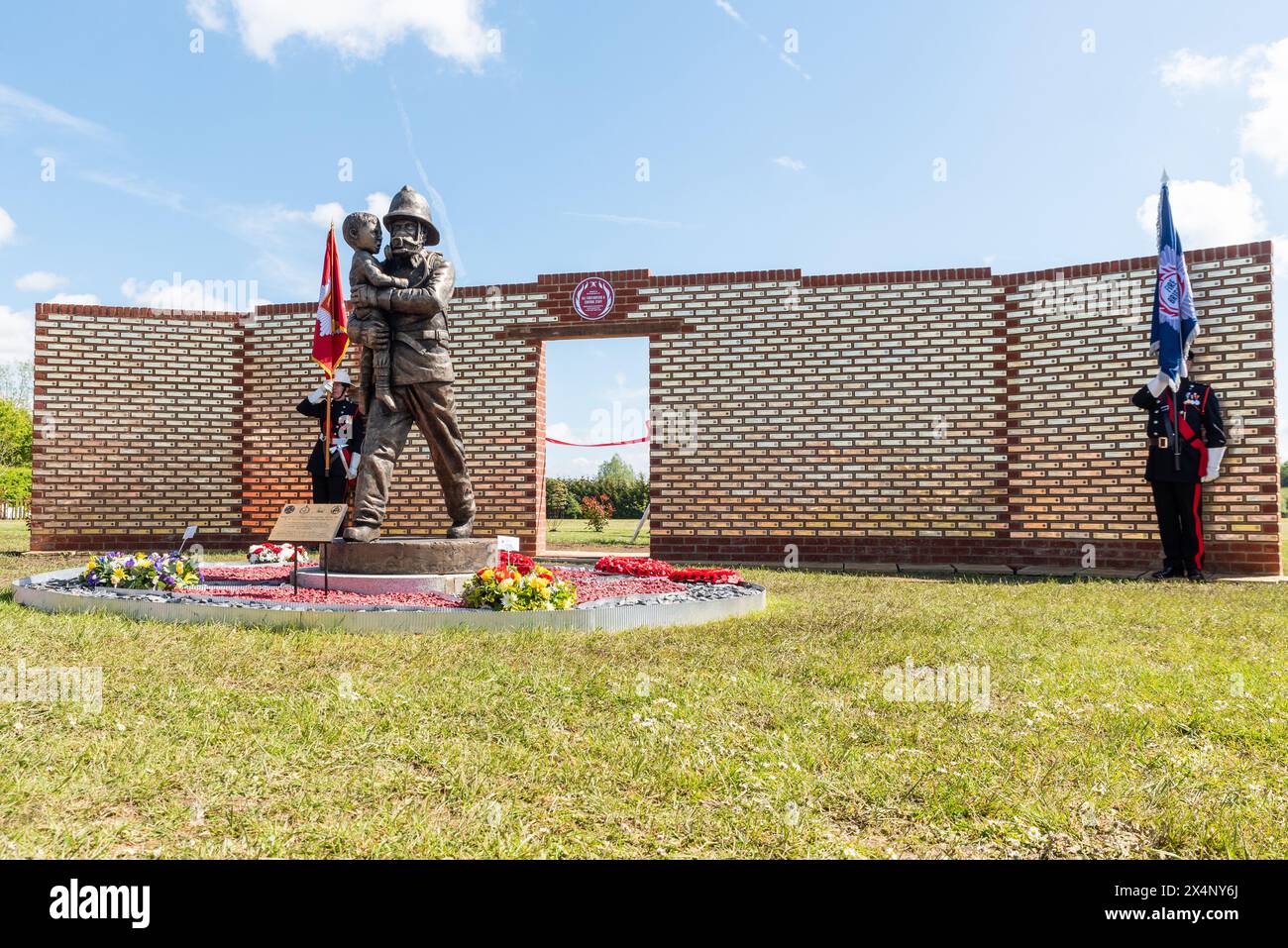 Firefighter statue, rescuing a child, at the unveiling and opening of ...
