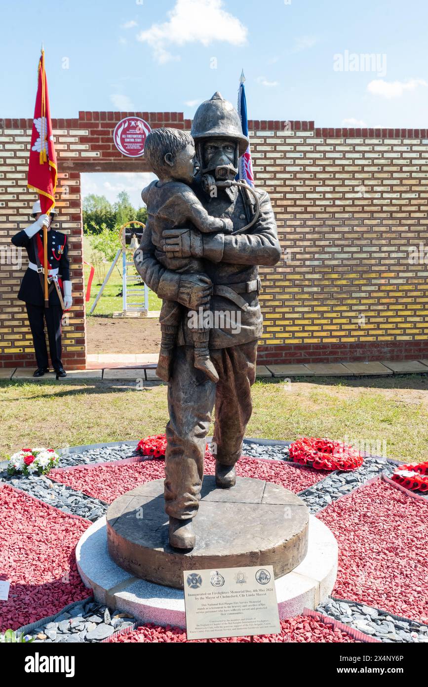 Firefighter statue, rescuing a child, at the unveiling and opening of ...