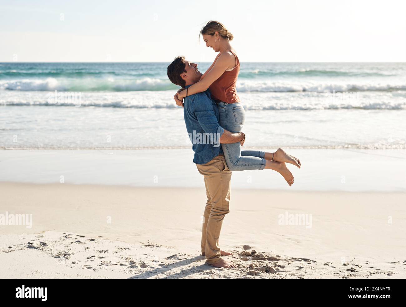 Couple, happy and lifting at beach with love, summer and travel for ...