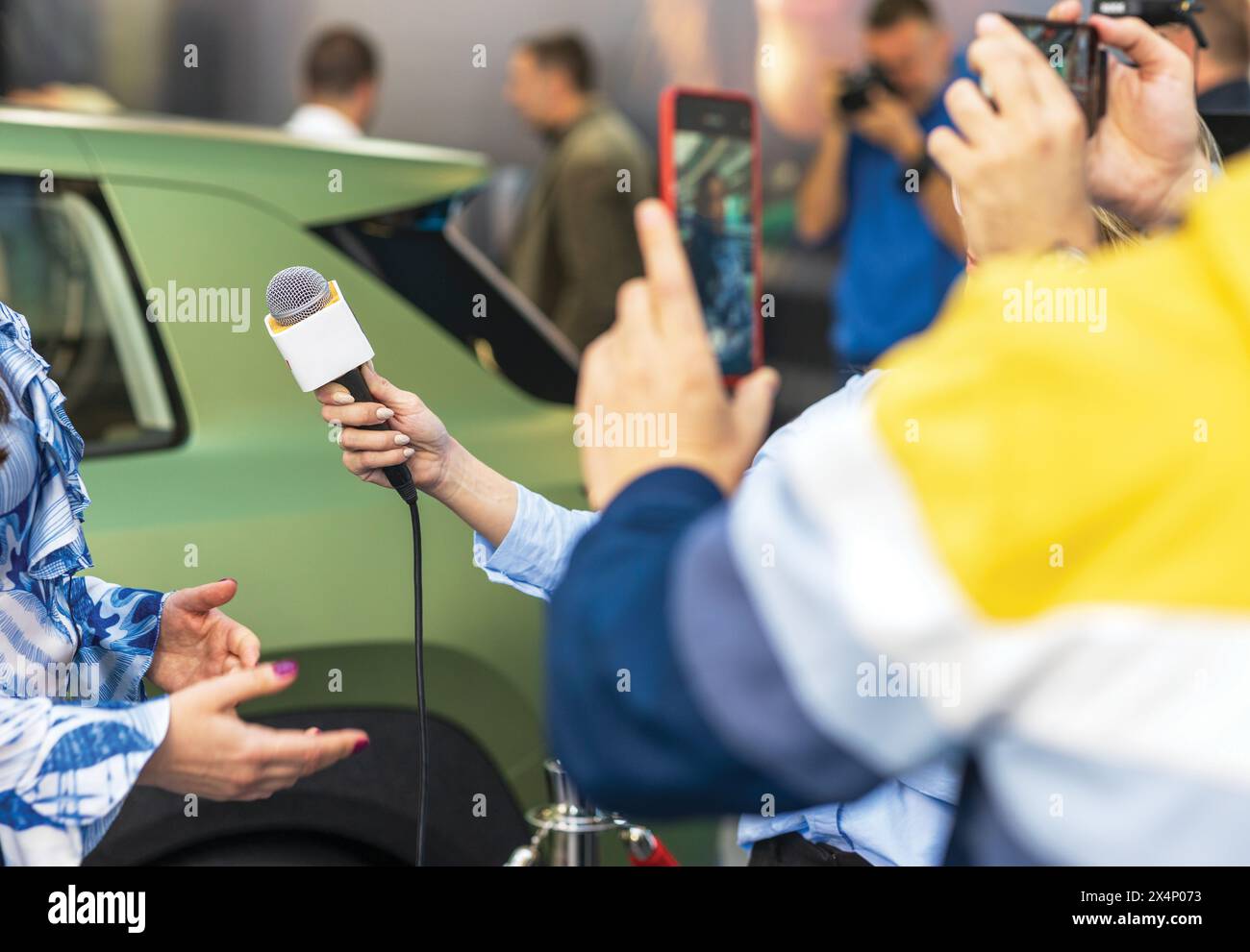 Mobile journalists filming and photographing media interview with a ...