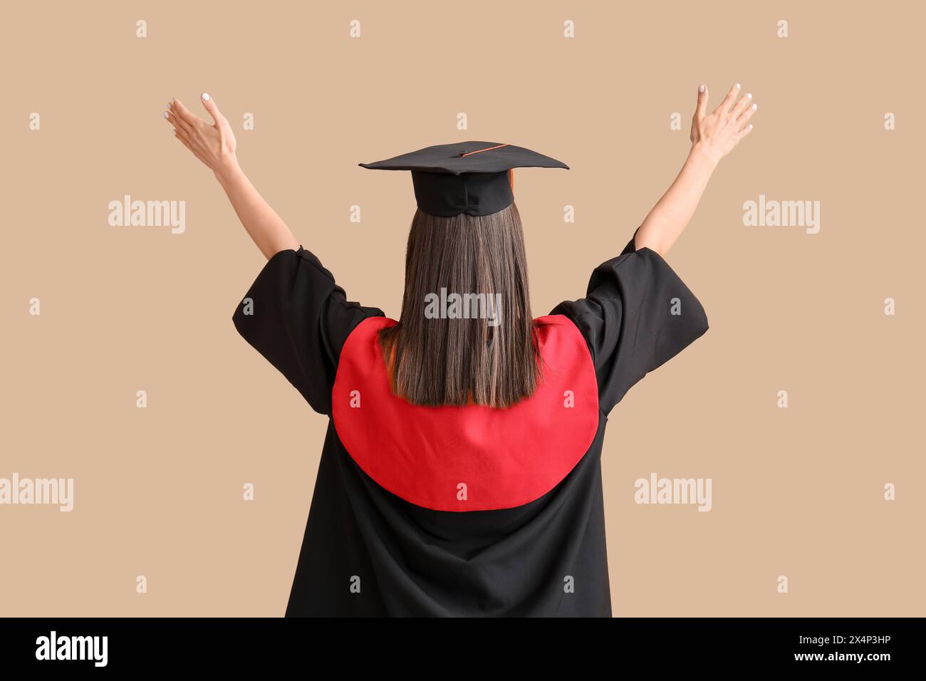 Cheerful female graduate on beige background, back view Stock Photo - Alamy