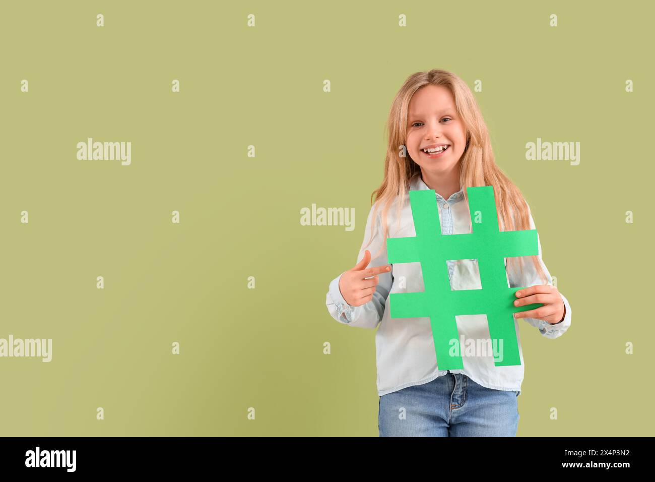 Cute teenage girl with hashtag on green background Stock Photo - Alamy