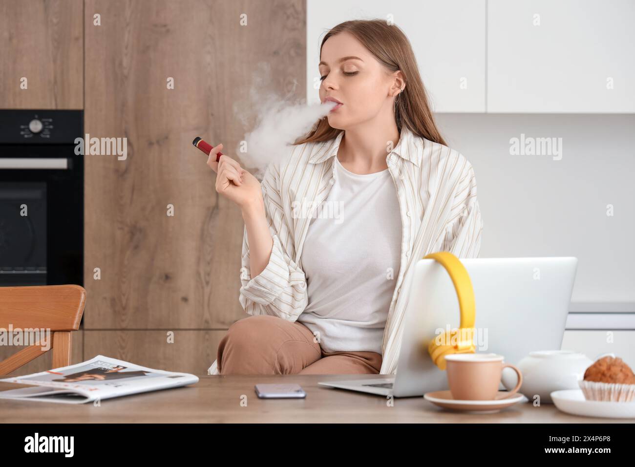 Woman smoking in kitchen hi-res stock photography and images - Alamy