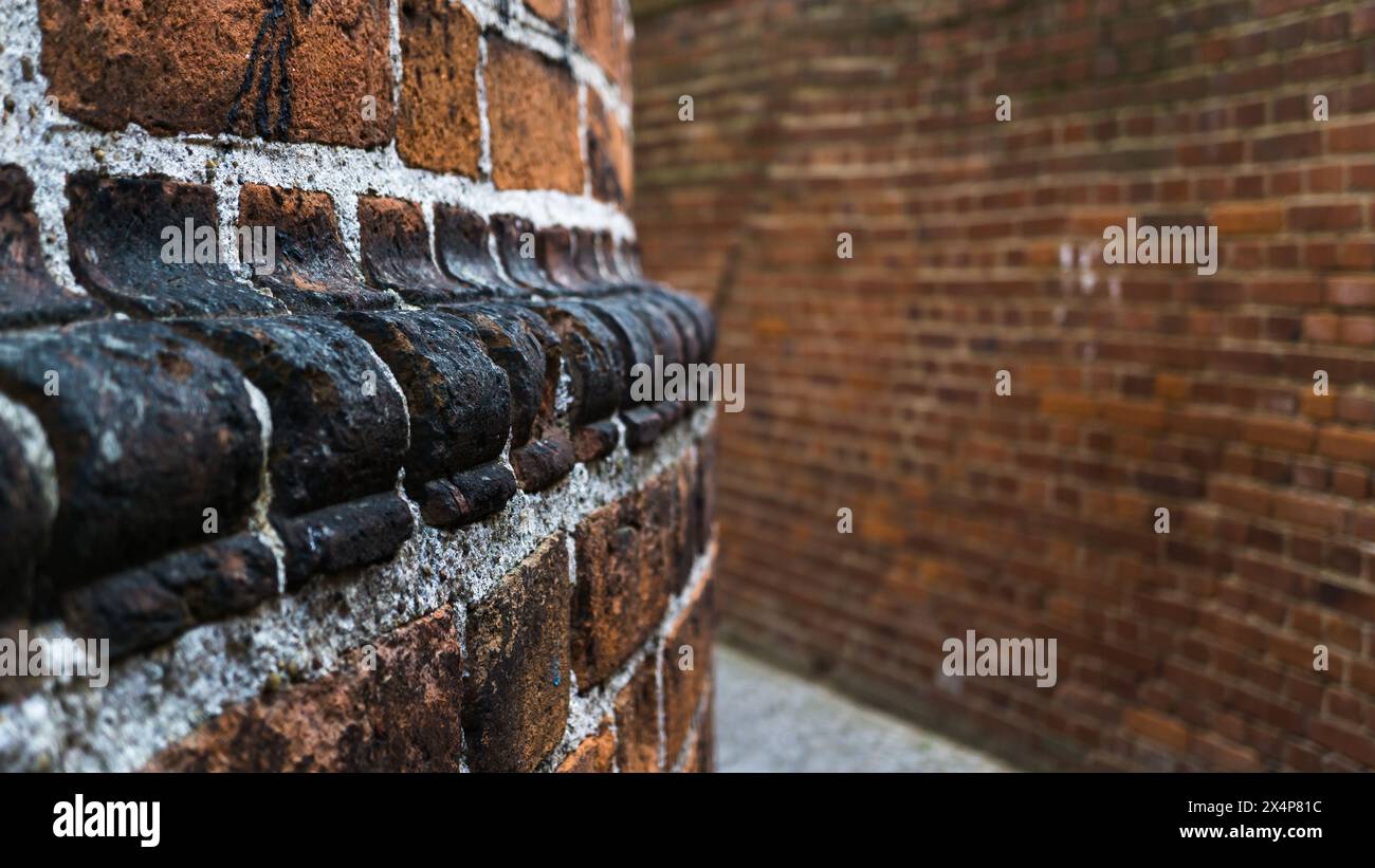 red brick wall with black stone line Stock Photo - Alamy