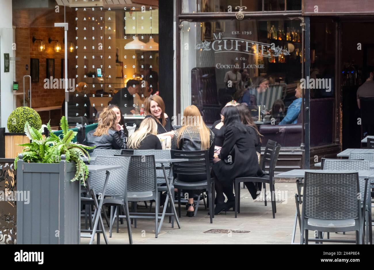 8 young female friends enjoying an alfresco drink at a Castle Street ...