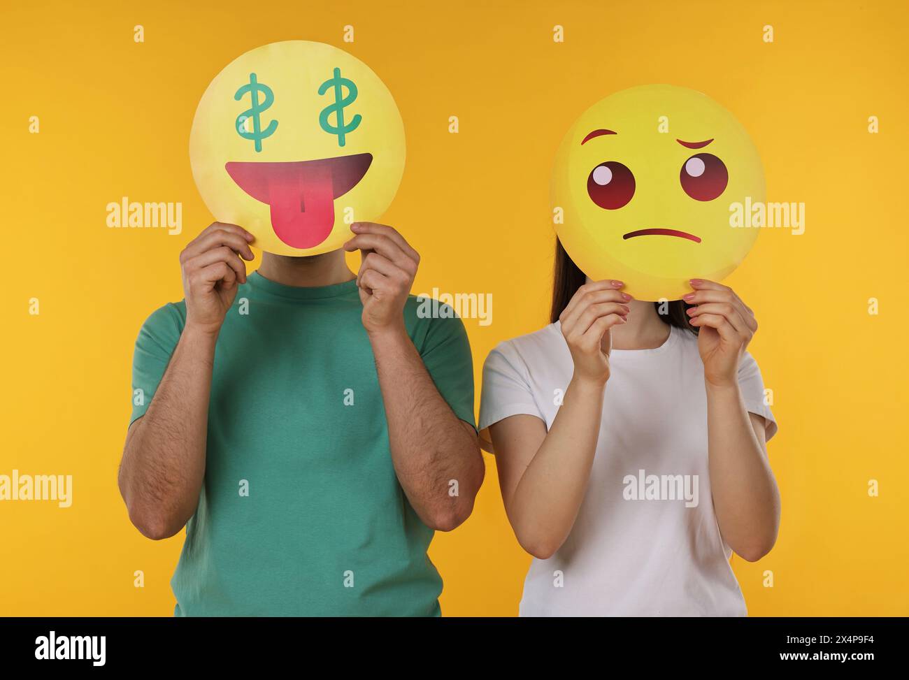 People covering faces with emoticons on yellow background Stock Photo ...