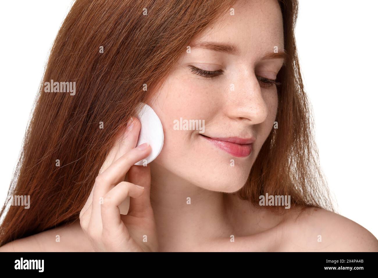 Beautiful woman with freckles wiping face on white background Stock ...